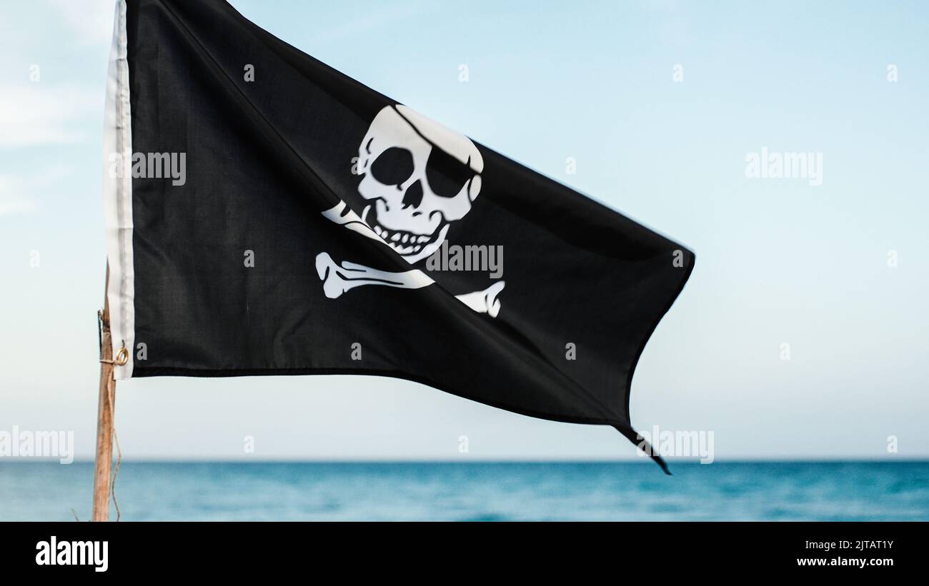 Pirates Flags Flutters In The Wind Stock Photo - Alamy