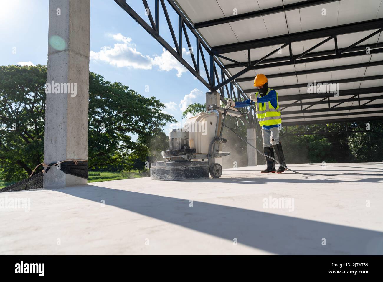 Construction worker produces the grout and finish wet concrete with a ...