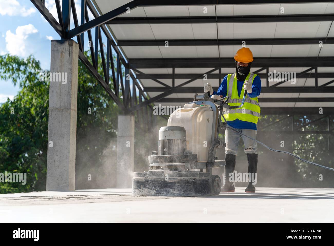 A Construction Worker Using Concrete Polishing Machine Or Polishing