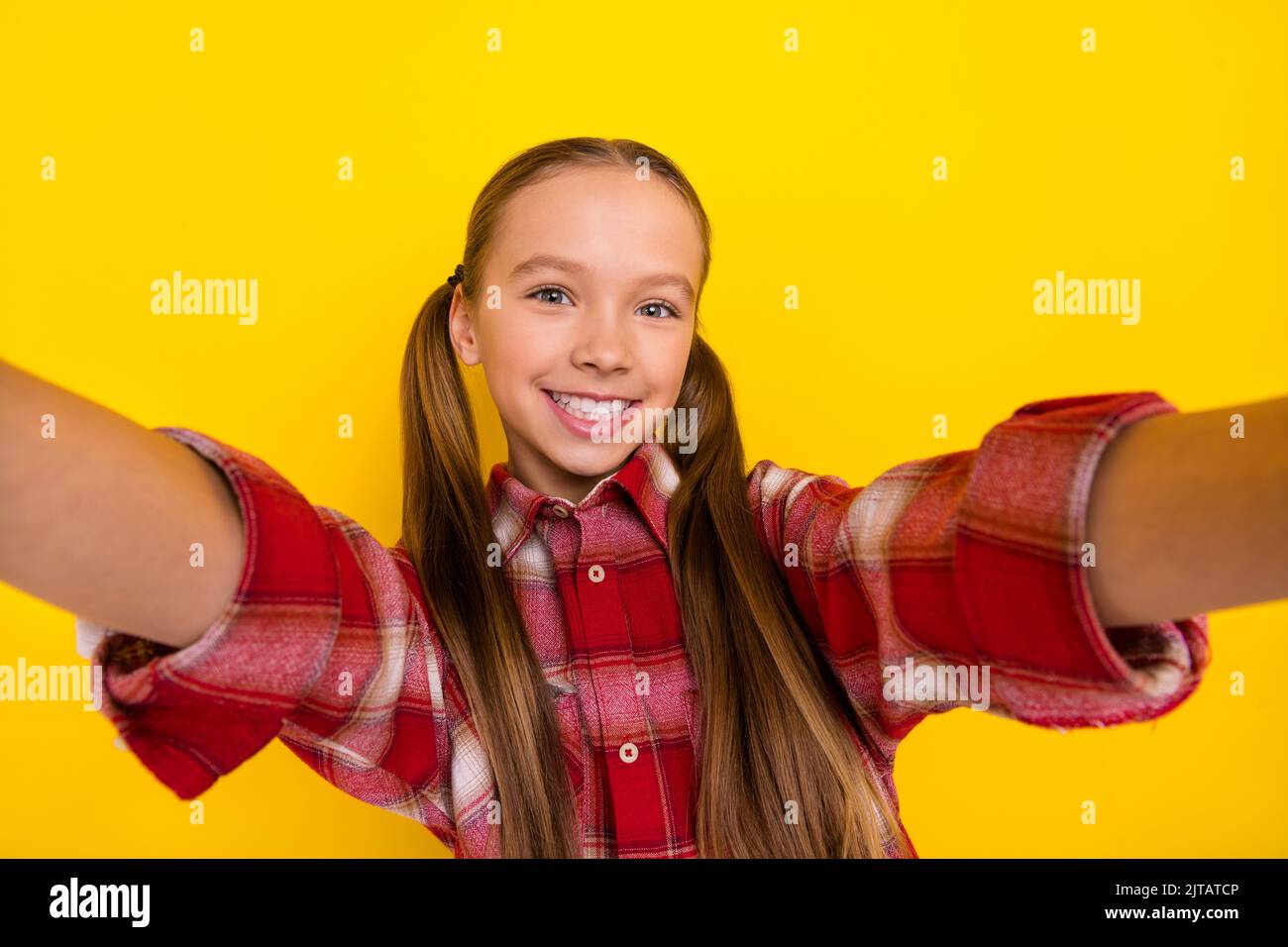 Photo of excited sweet schoolkid dressed plaid shirt tacking selfie ...