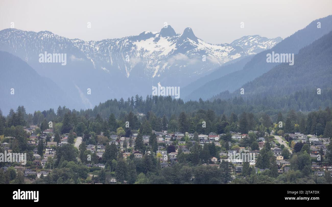 Residential Homes in a modern city with mountain peaks in background ...