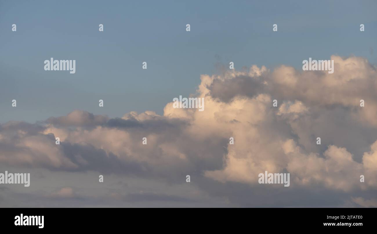 Puff Clouds in the Sky during sunset Stock Photo - Alamy