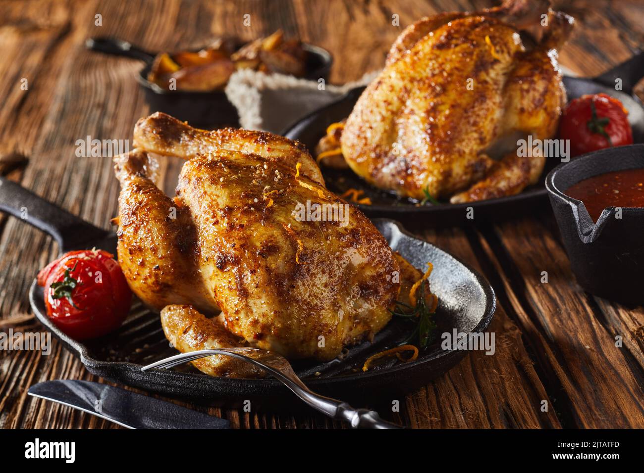 From above yummy whole roasted chickens with tomatoes served for lunch ...
