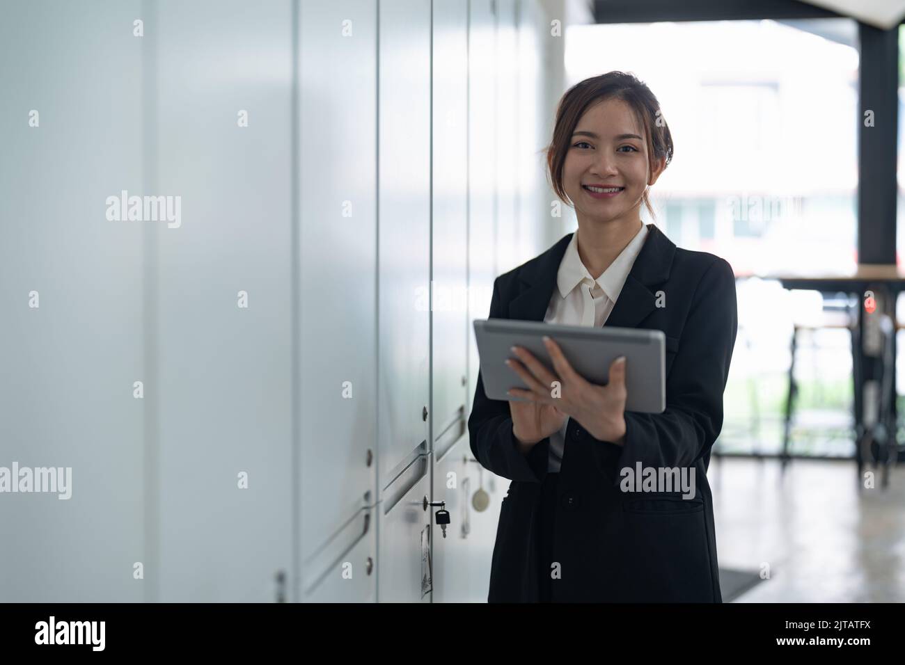 Portrait asian business woman with stylus pen writing on digital ...