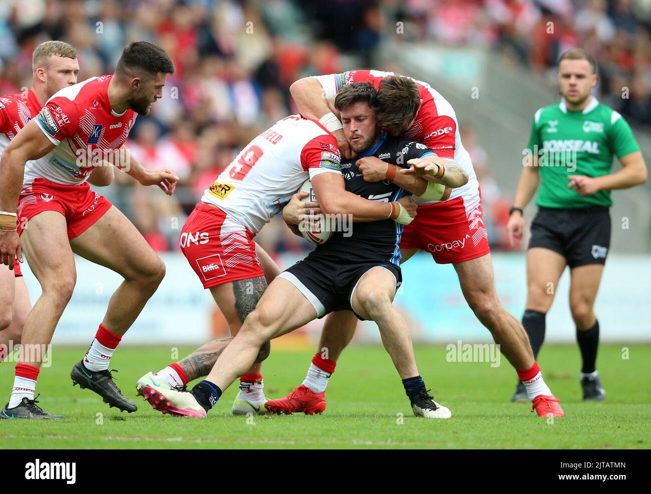 Wakefield Trinity's Kyle Evans (centre) is tackled by St Helens' Jake ...