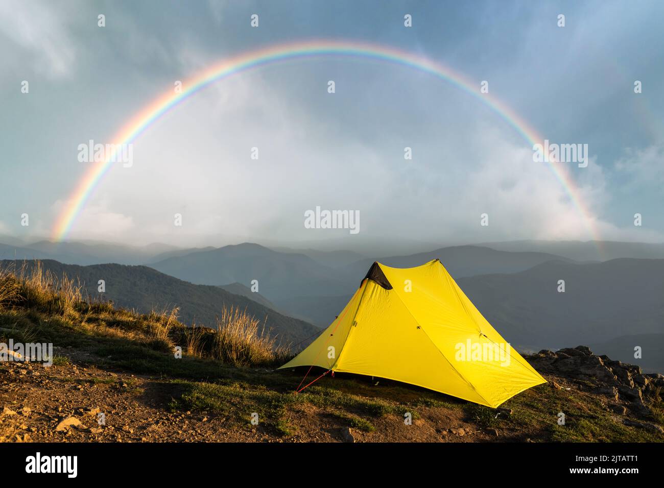 Yellow tent against the backdrop of an incredible mountain landscape ...