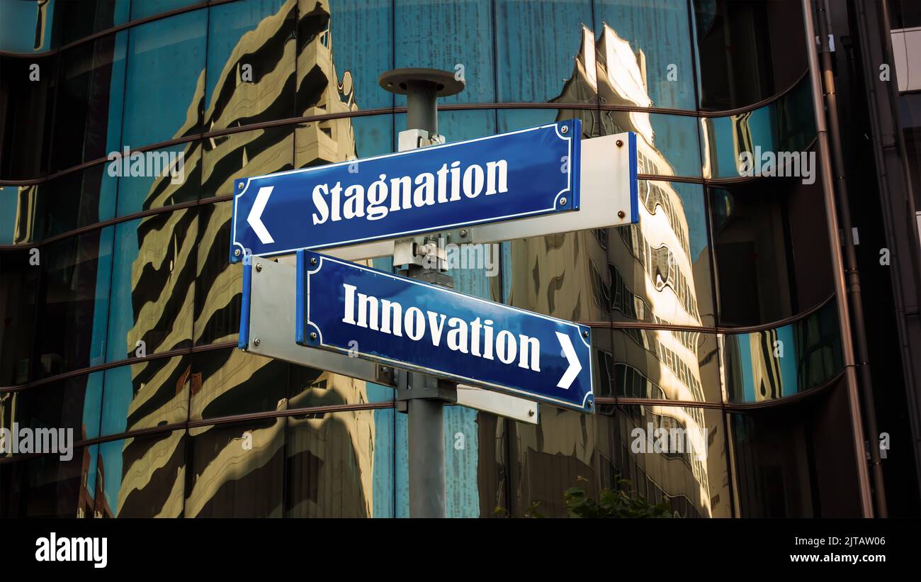 Street sign innovation versus stagnation hi-res stock photography and ...