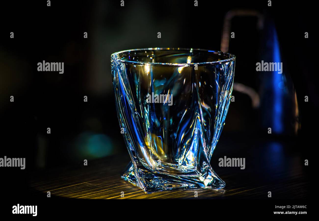 An empty glass beaker glows on a dark background Stock Photo - Alamy