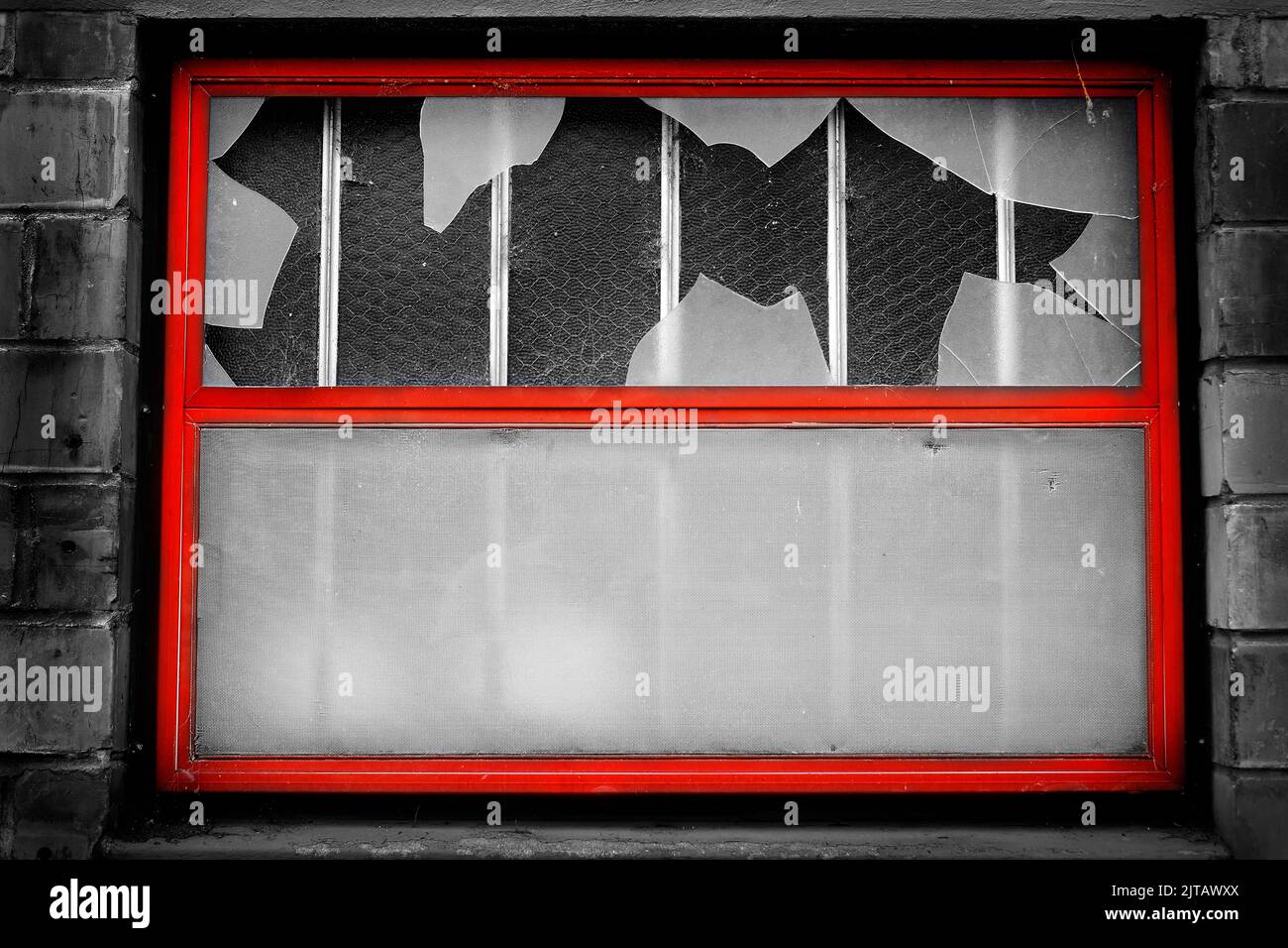 Window on building with broken glass shattered by vandalism destruction ...