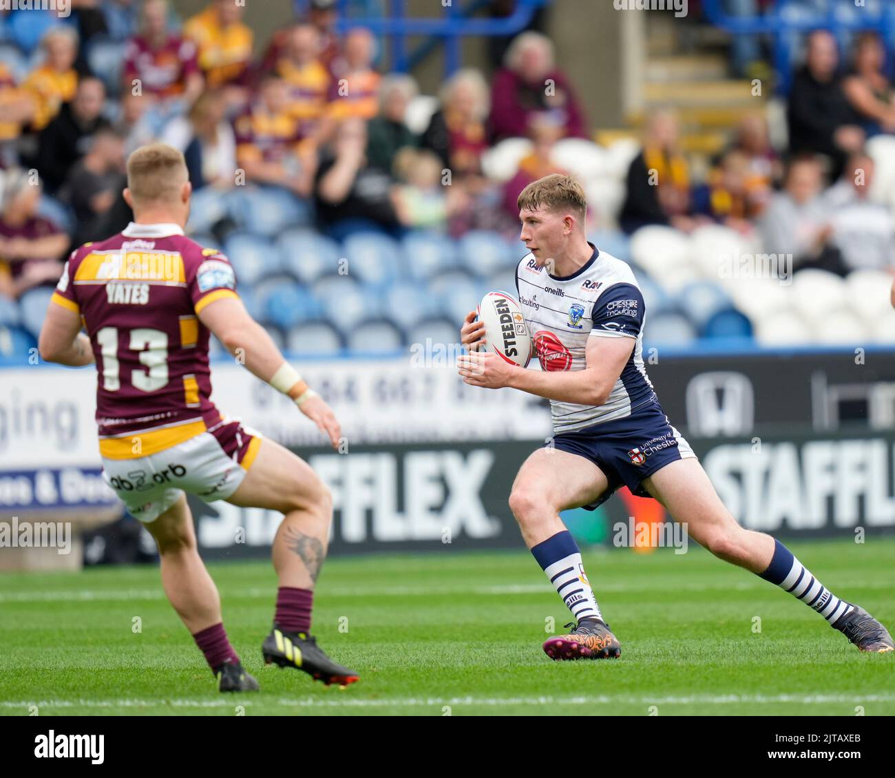 Matty Nicholson #35 of Warrington Wolves runs at Luke Yates #13 of ...