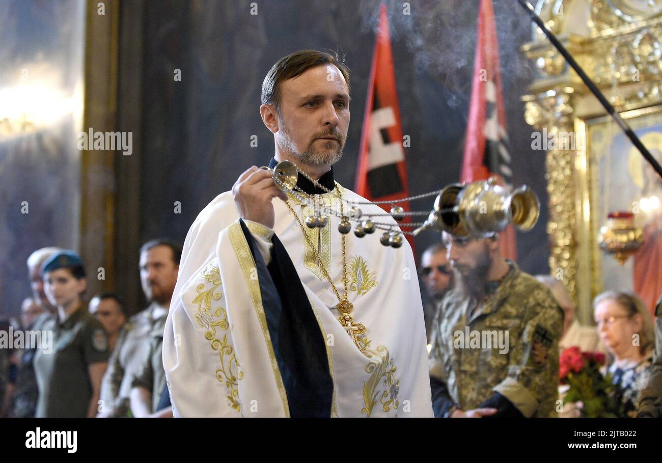 KYIV, UKRAINE - AUGUST 28, 2022 - A priest swings a censer during a ...