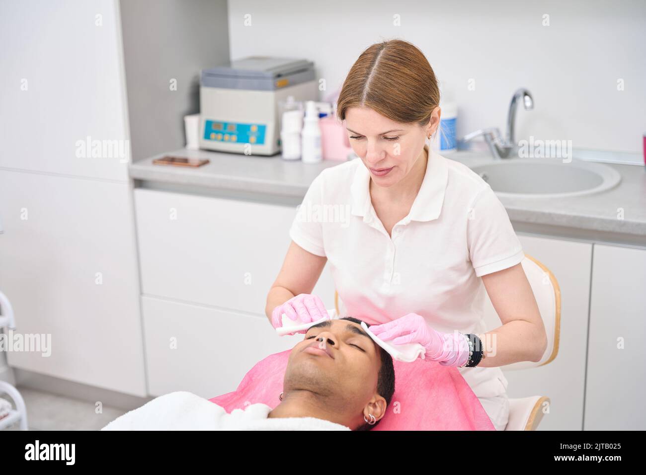 Dermatologist male preparing woman hi-res stock photography and images ...