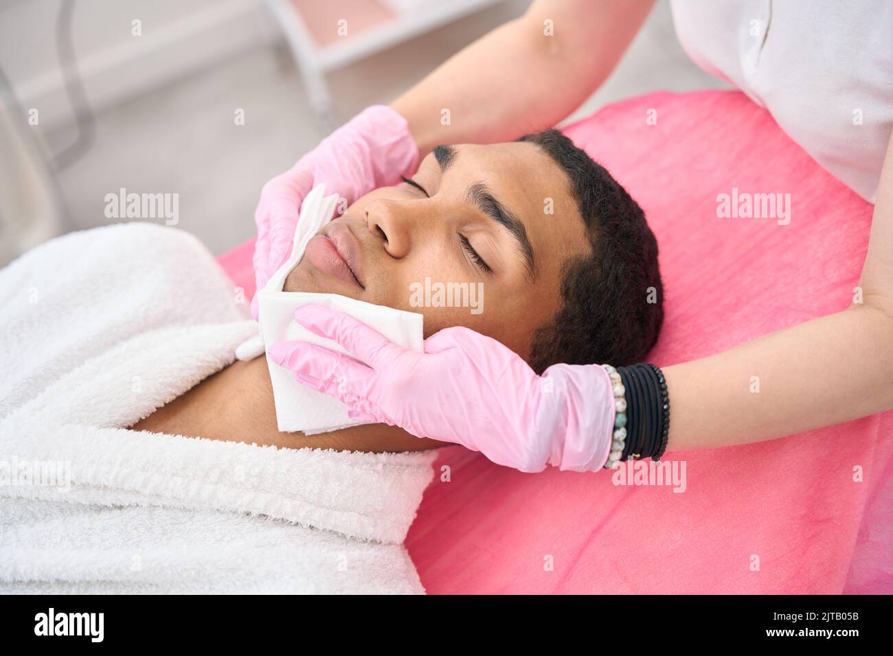 Beauty salon aesthetician preparing client for cosmetic procedure Stock ...