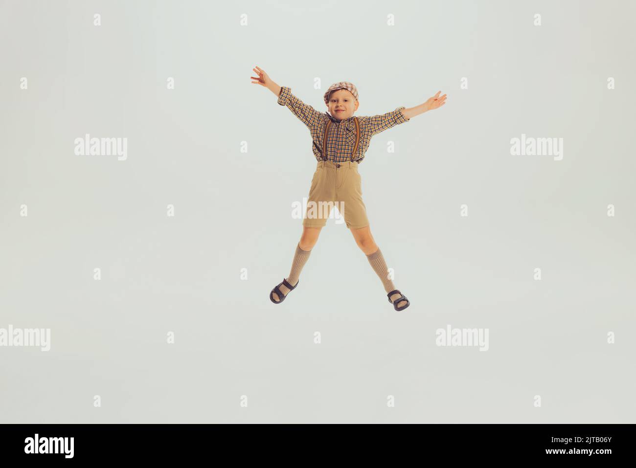 Portrait of little smiling boy, child in beige checkered shirt playing ...