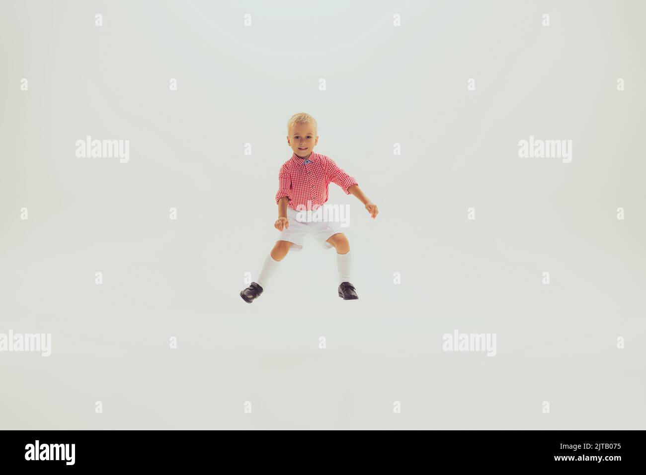 Portrait of little smiling boy, child in pink checkered shirt playing ...