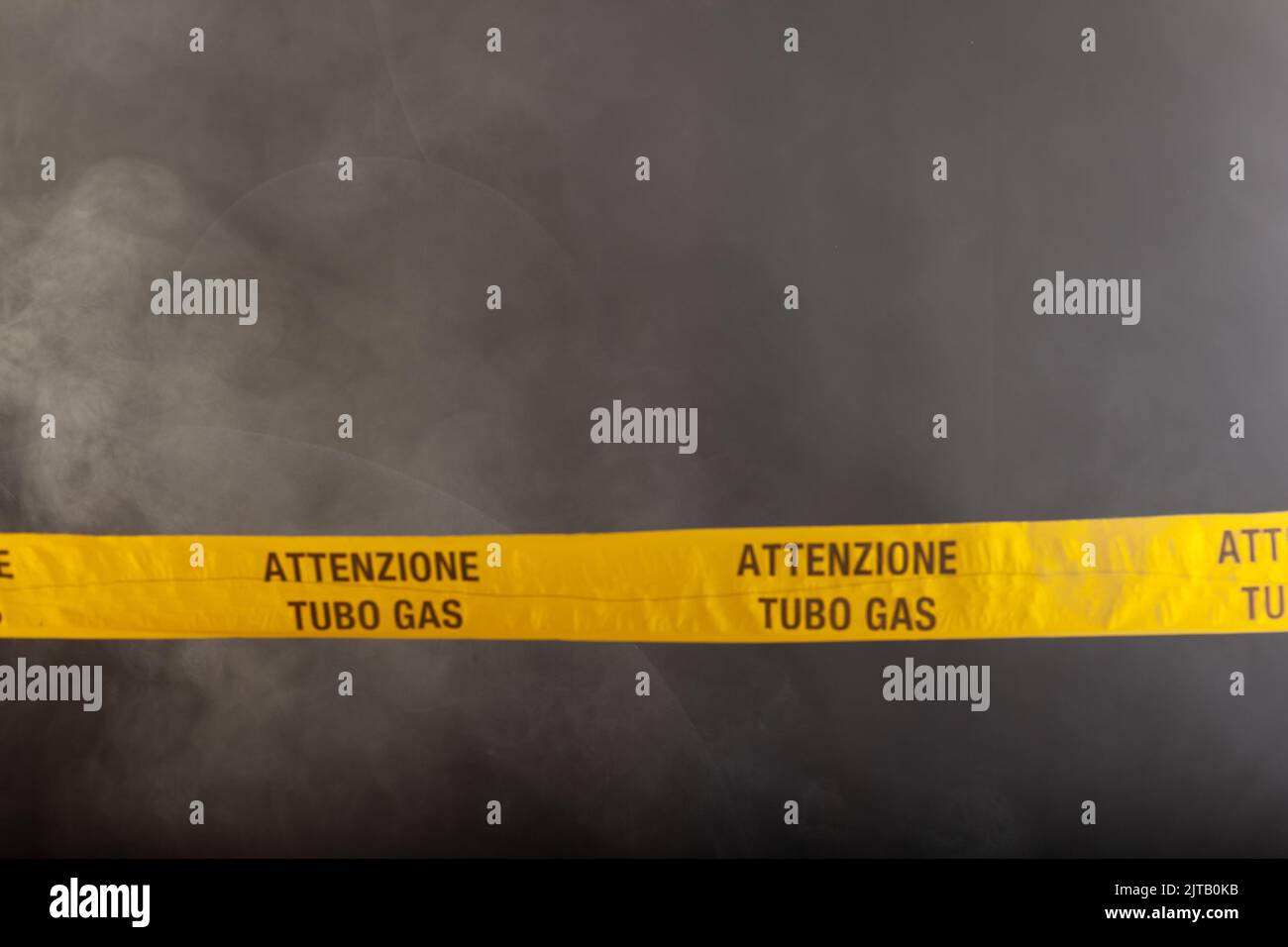 Yellow emergency sign of attention gas pipe on smoke-filled background ...