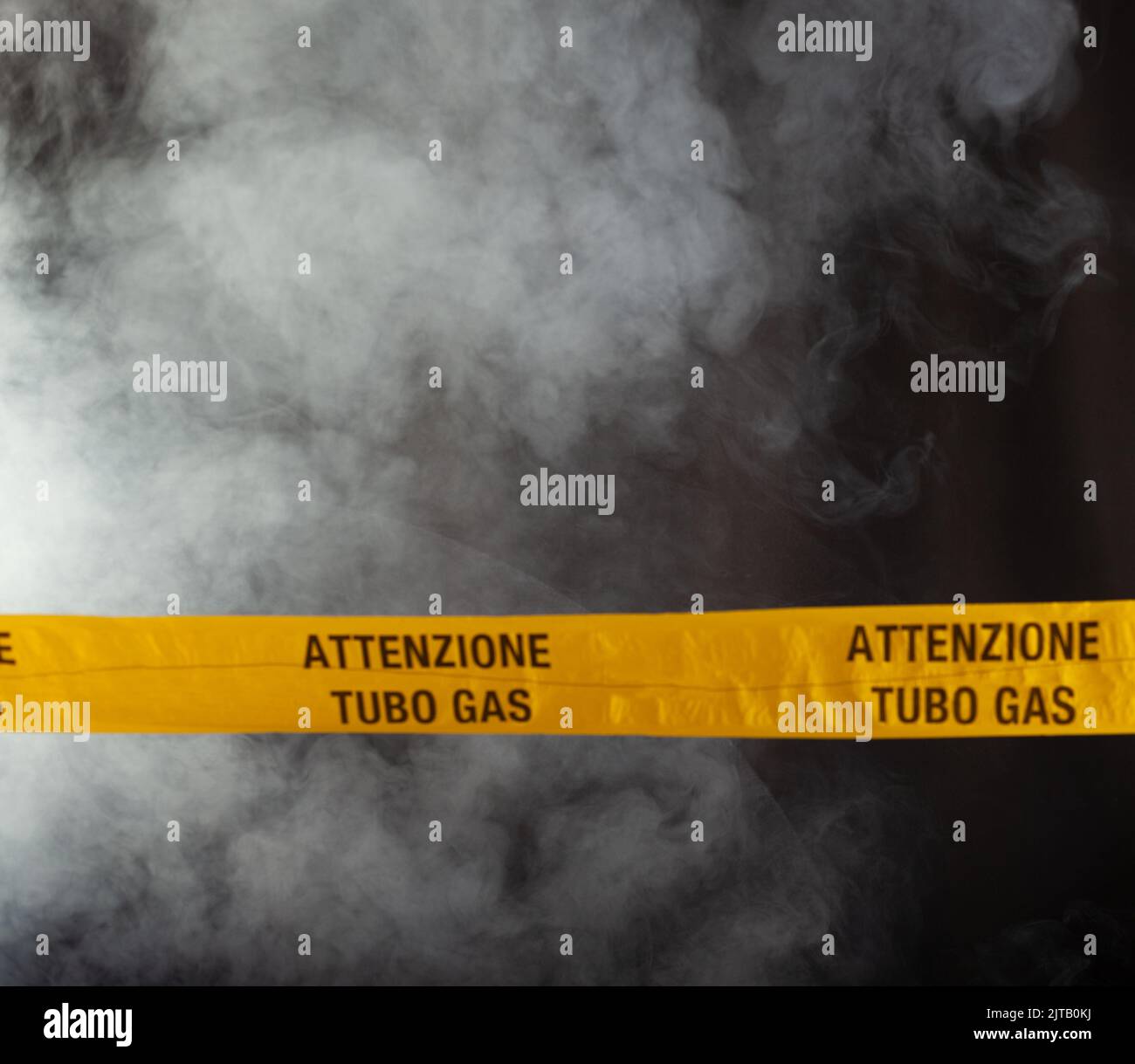 Yellow emergency sign of attention gas pipe on smoke-filled background ...