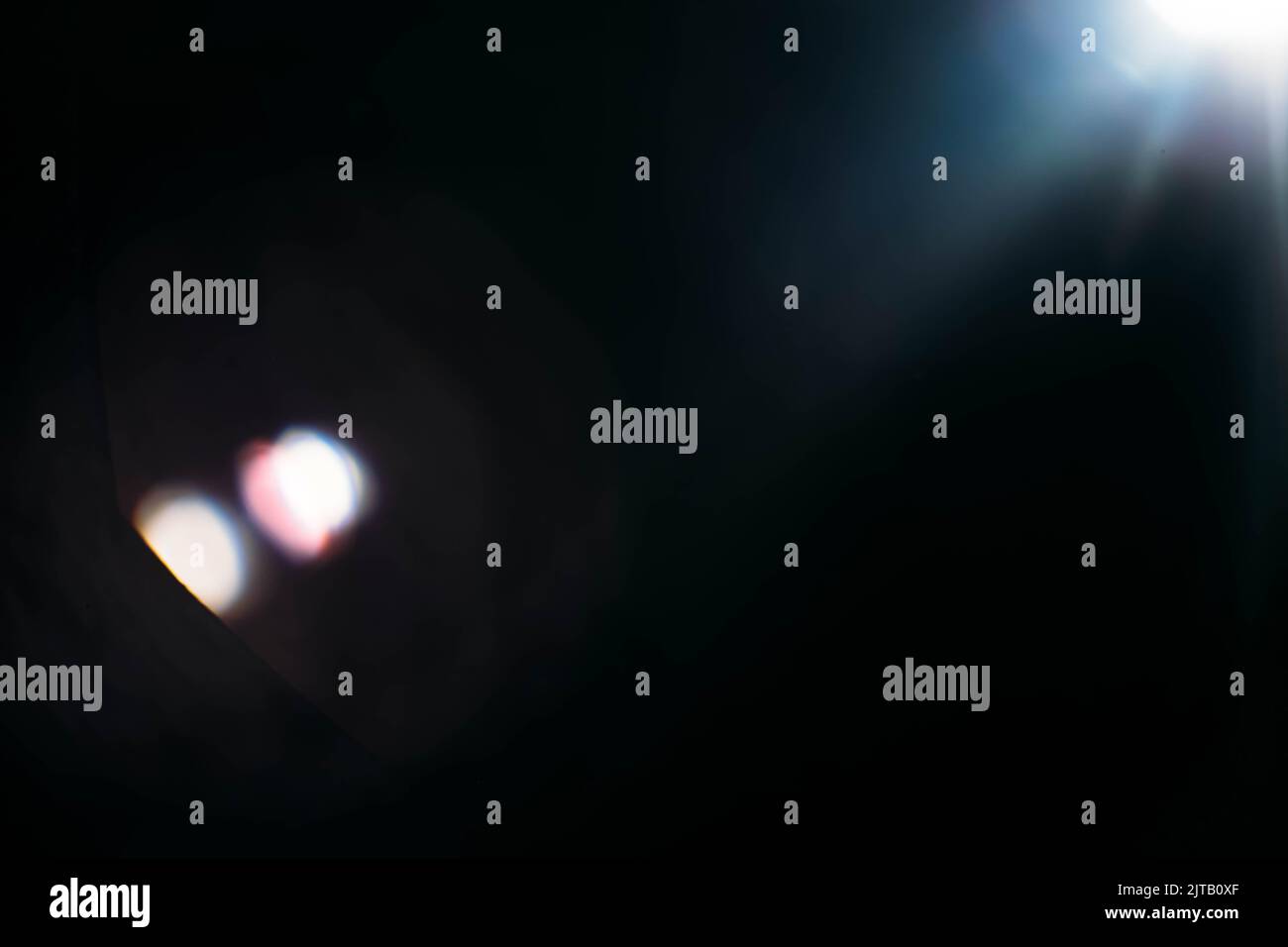 white lens flare dark background light dots effect Stock Photo - Alamy