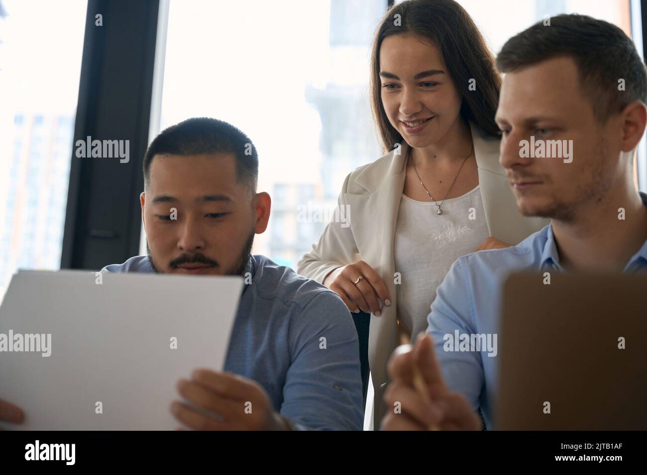 Employees discussing in office typing hi-res stock photography and ...