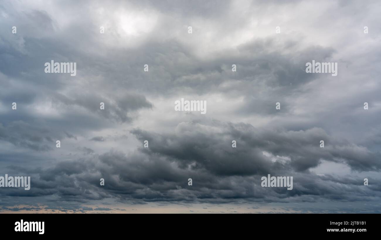 Dark cumulus thunderstorm clouds background Stock Photo - Alamy