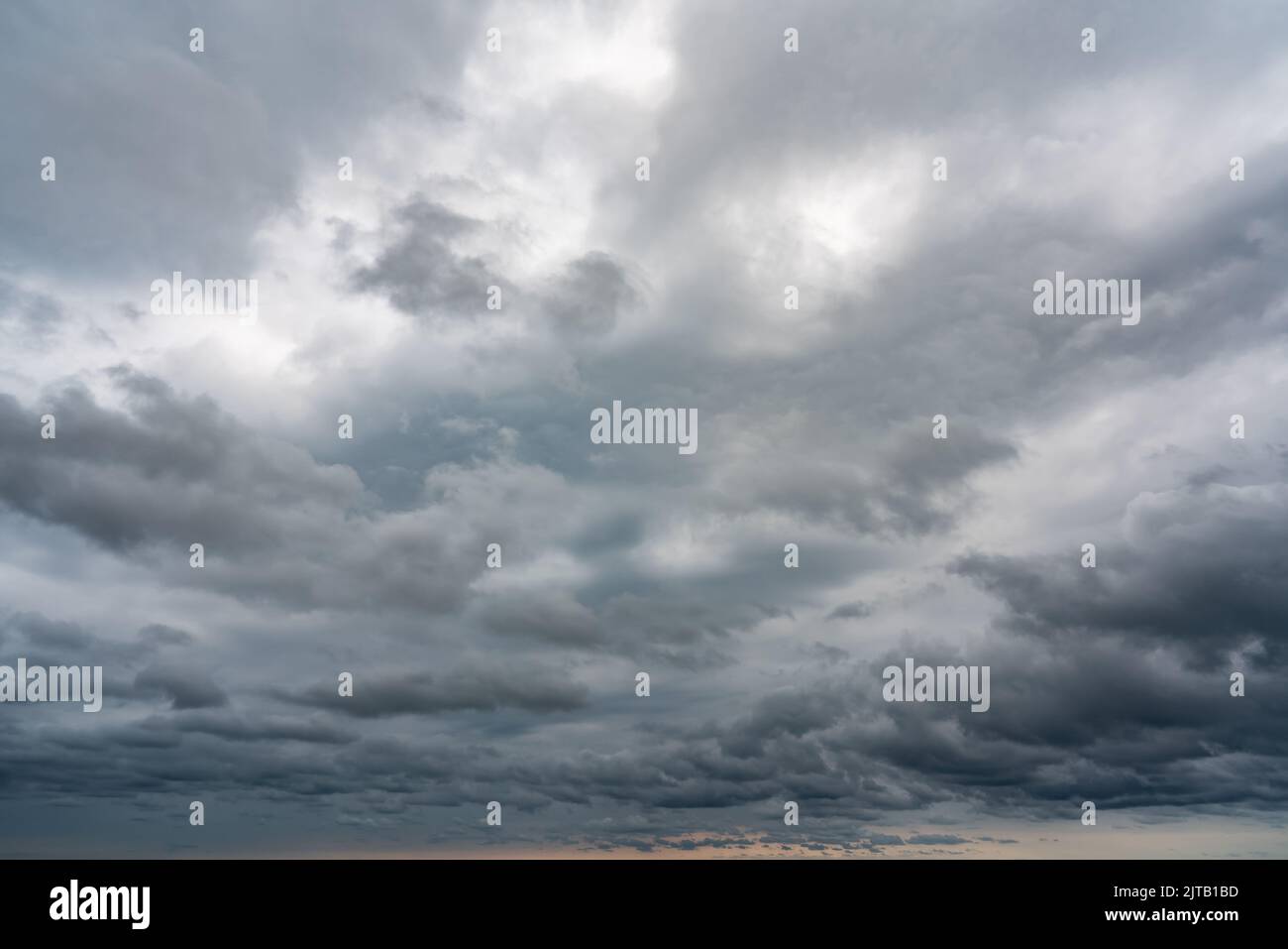 Dark cumulus thunderstorm clouds background Stock Photo - Alamy