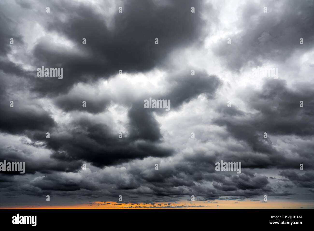 Dark cumulus thunderstorm clouds background Stock Photo - Alamy
