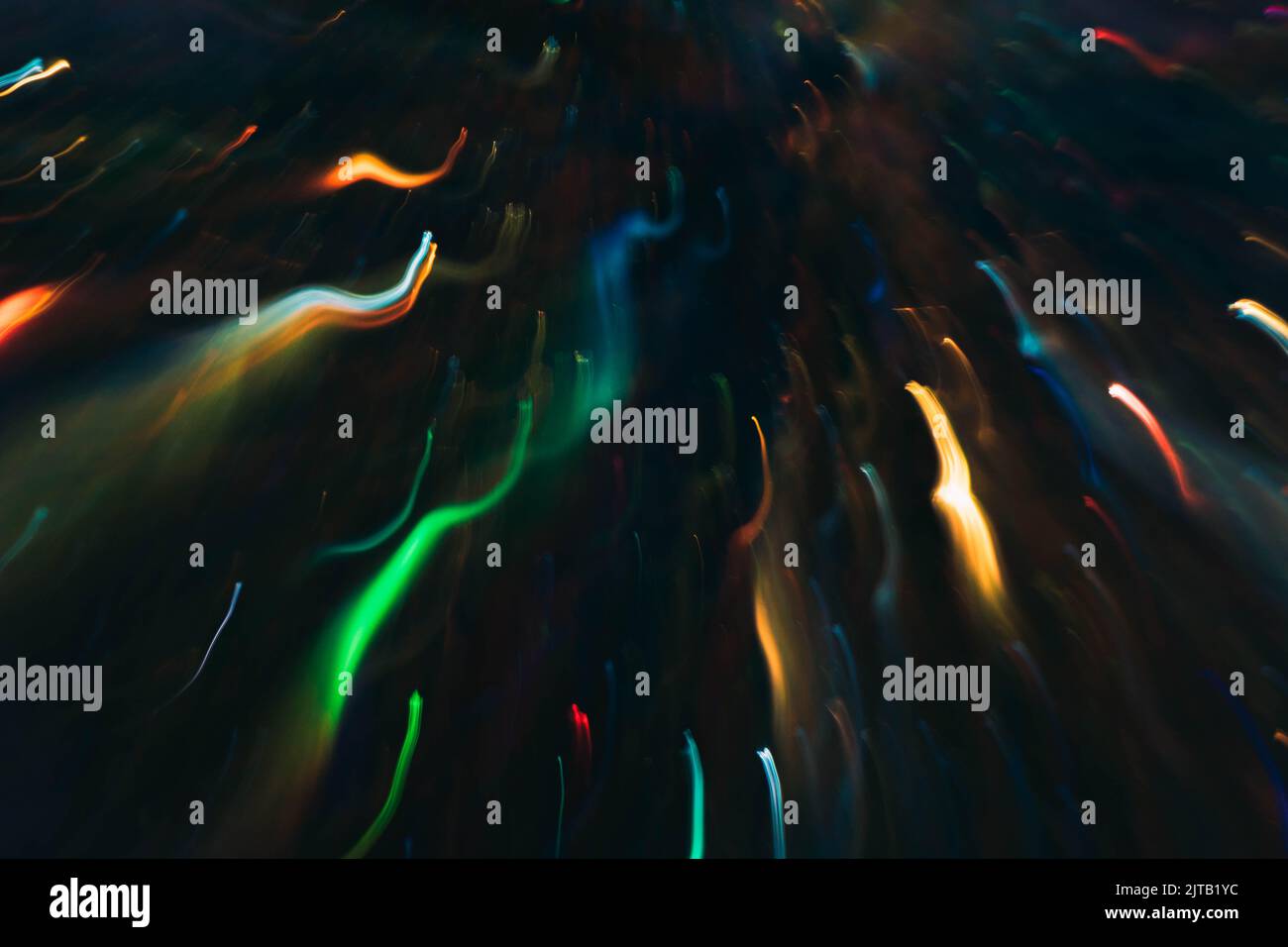 neon multicolor glowing curvy lines falling sparks Stock Photo - Alamy