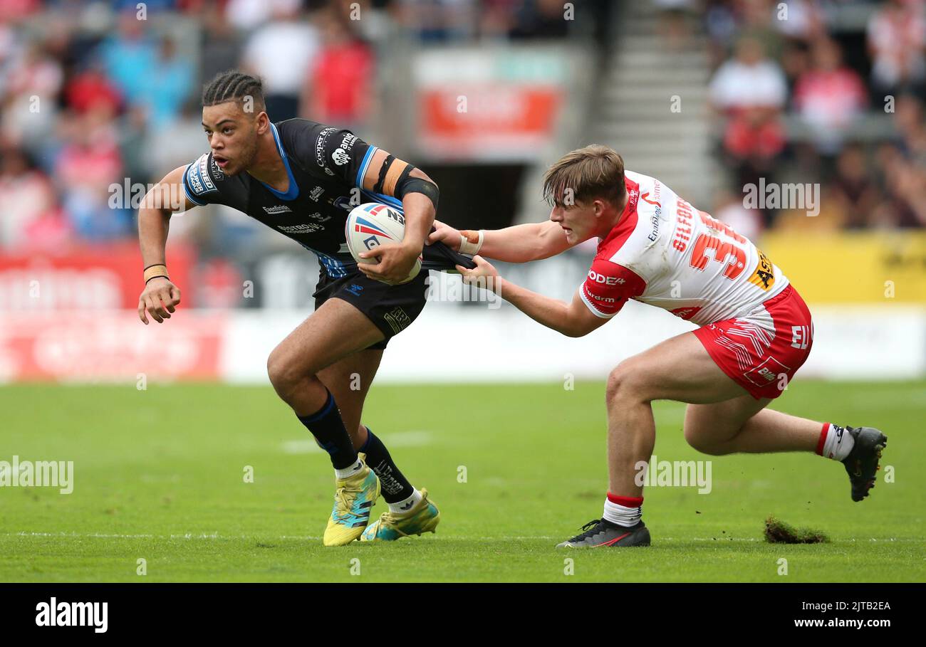 Wakefield Trinity's Lewis Murphy (left) is tackled by St Helens' Keane ...