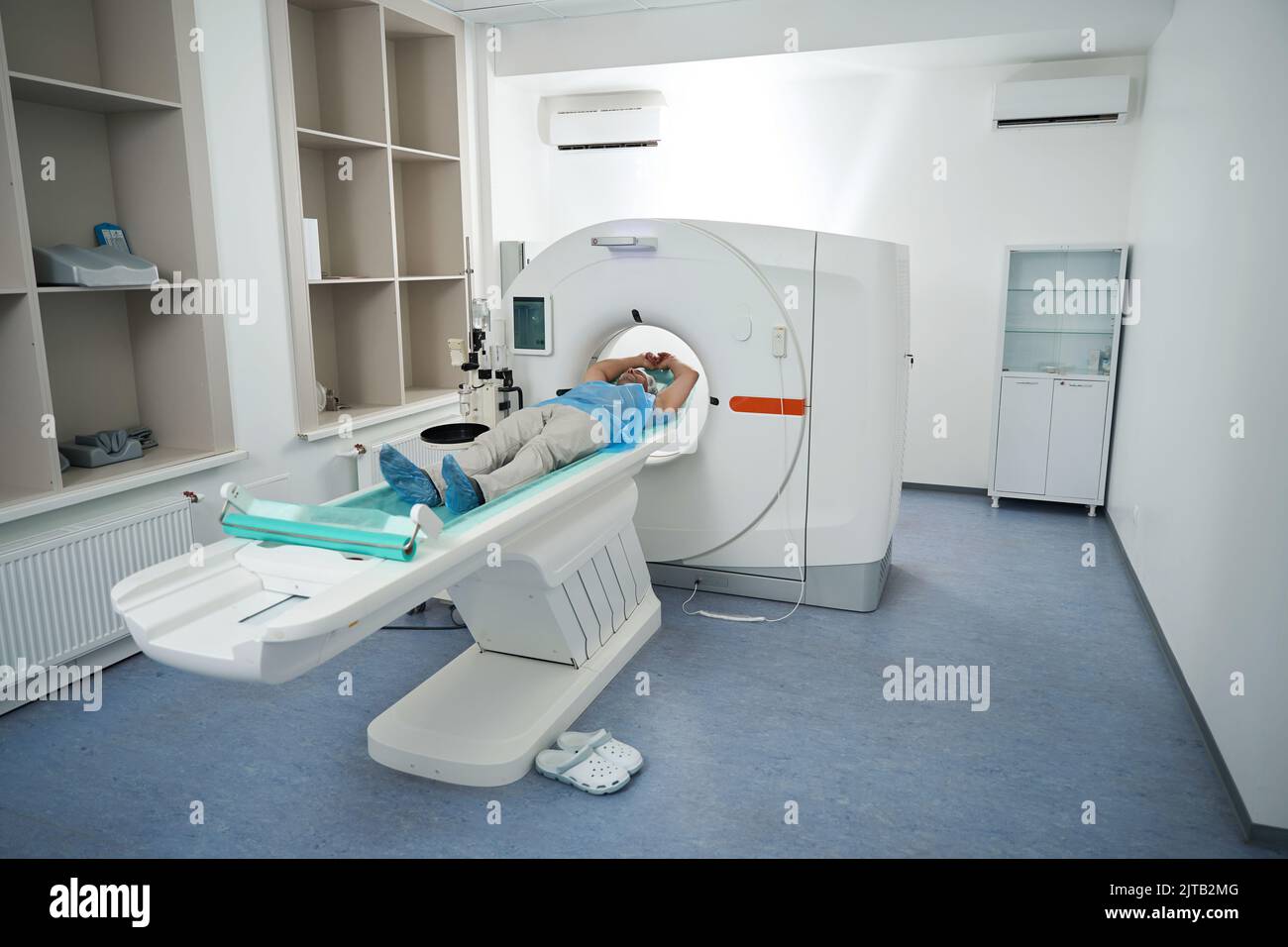 Man in the tomography room undergoes a diagnostic procedure Stock Photo ...