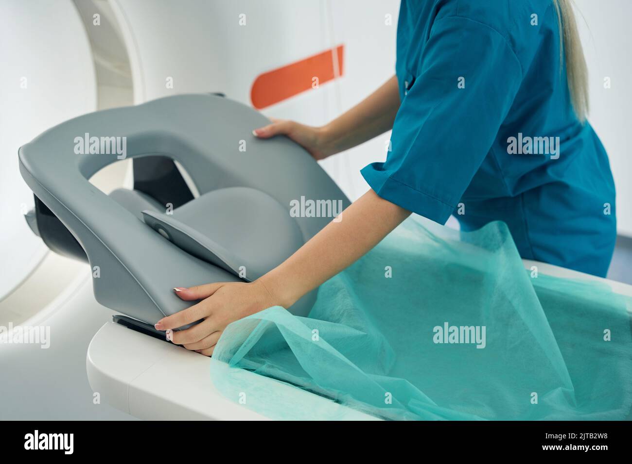 Nurse covers the couch of the CT scanner with sheet Stock Photo - Alamy