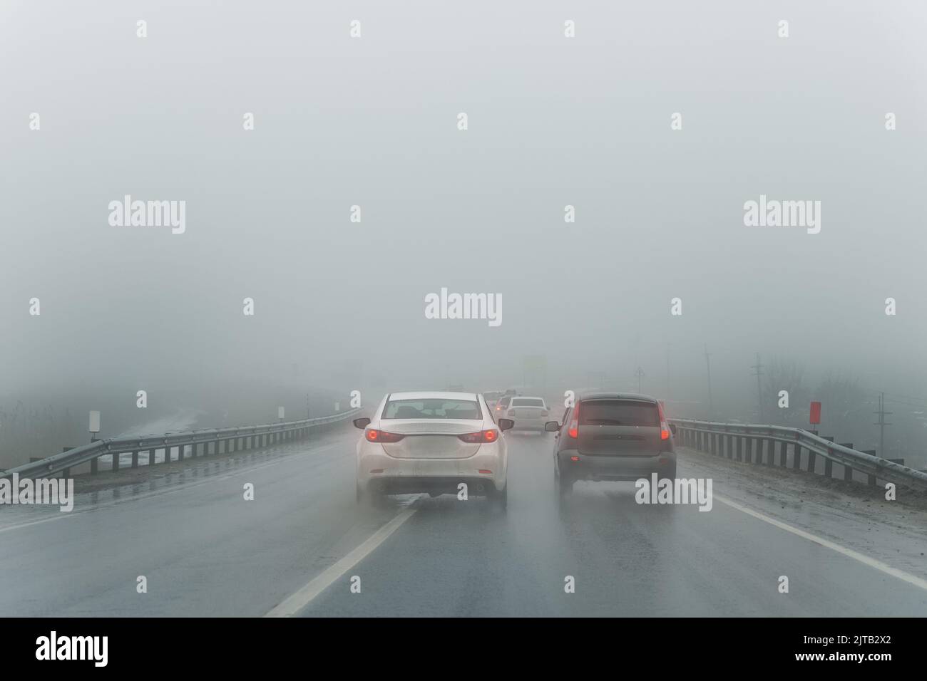 Car overtake rules violation crossing double lane. traffic on foggy ...