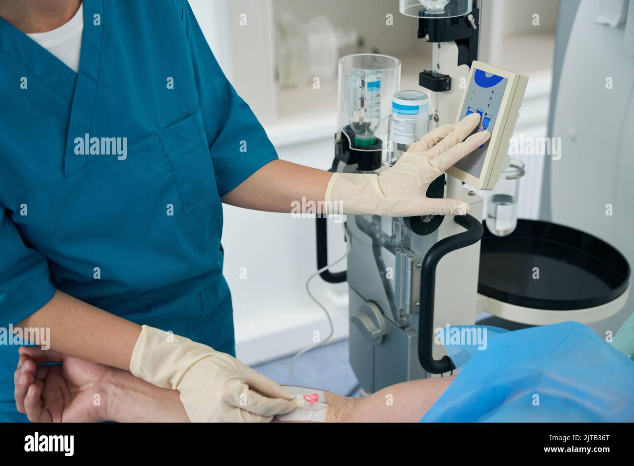 Medical worker puts a drip on a patient in a medical center Stock Photo ...