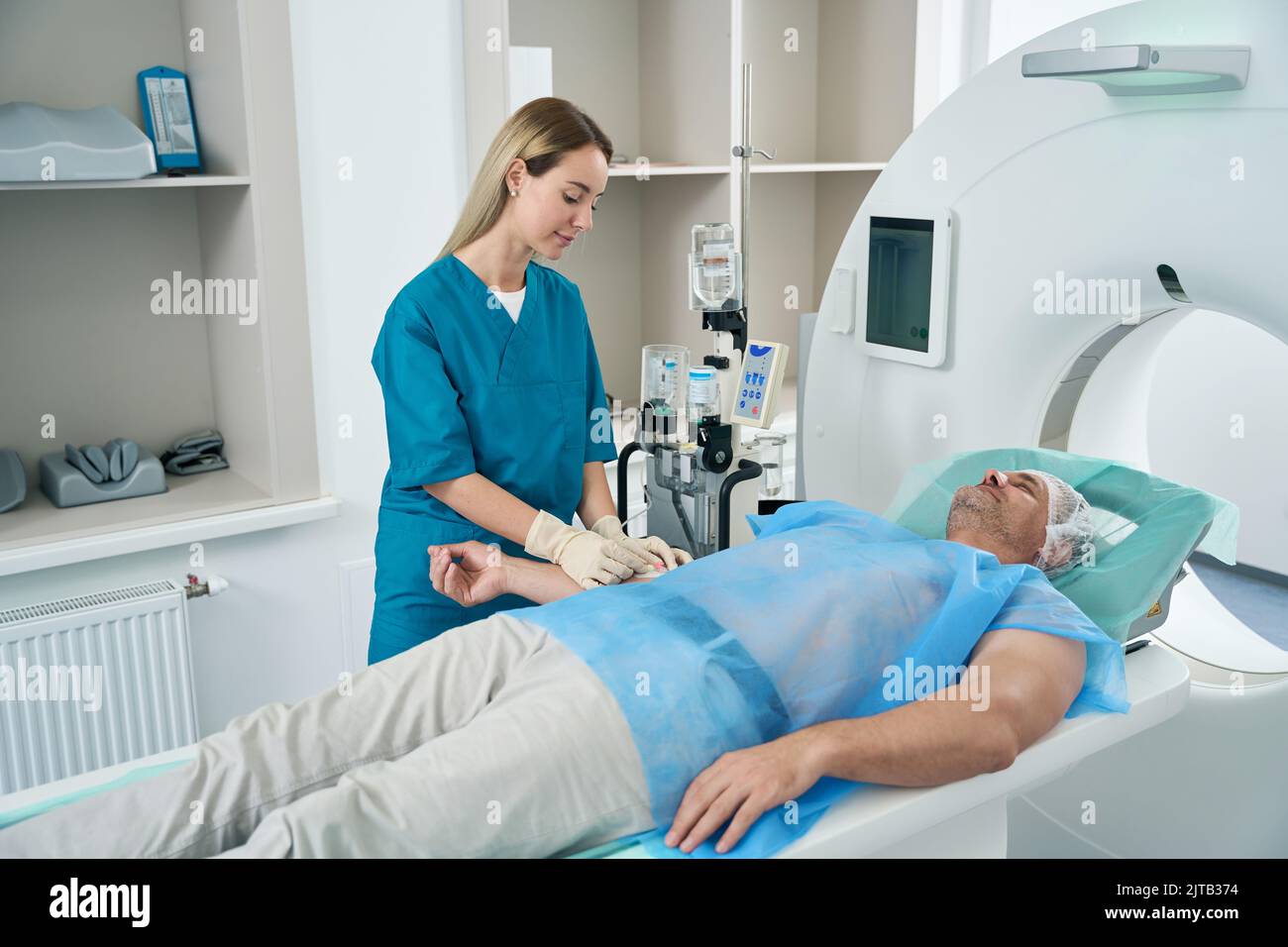 Nurse injecting medicine into patient's arm at medical center Stock ...