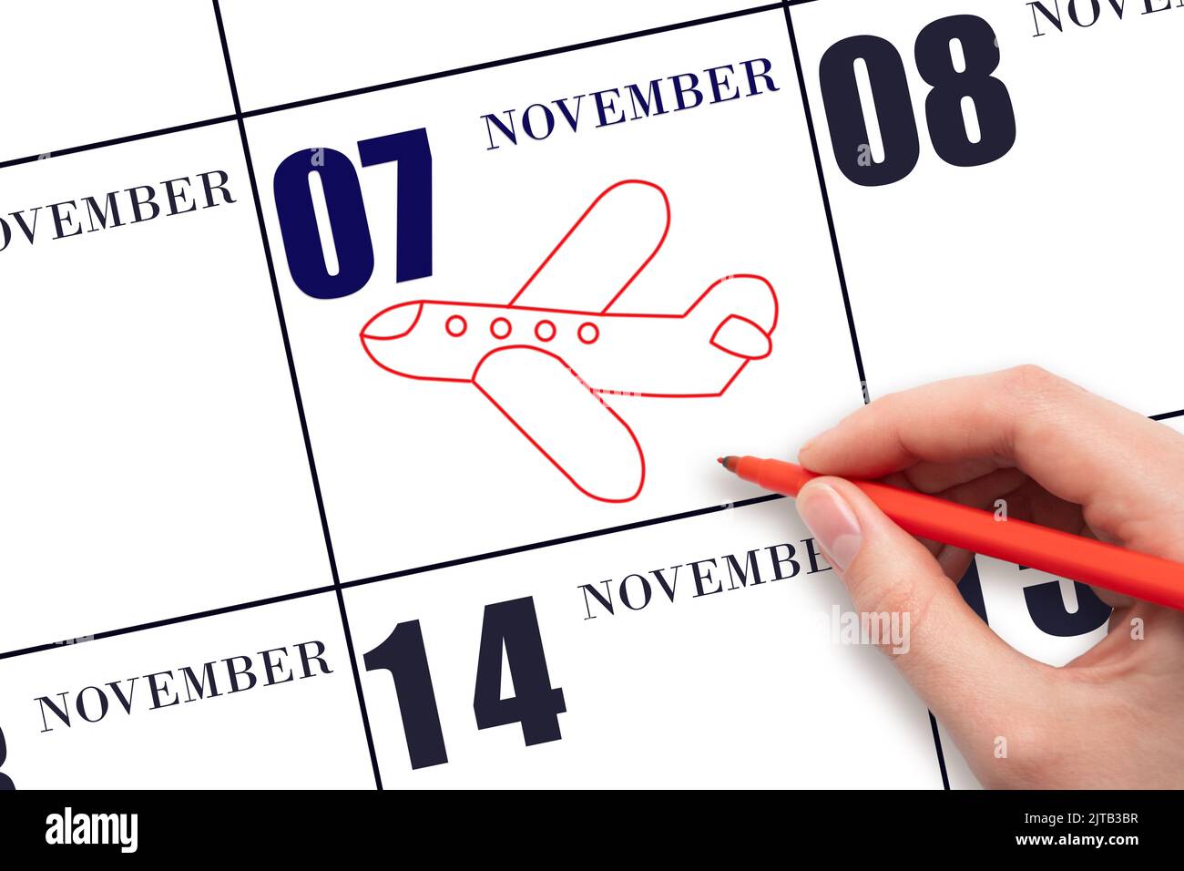 7th day of November. A hand drawing outline of airplane on calendar ...