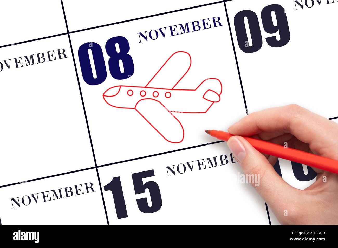 8th day of November. A hand drawing outline of airplane on calendar ...