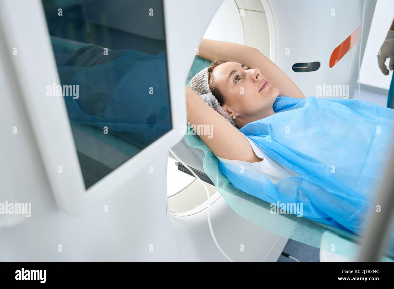 Woman undergoing a CT scan procedure in clinic Stock Photo - Alamy