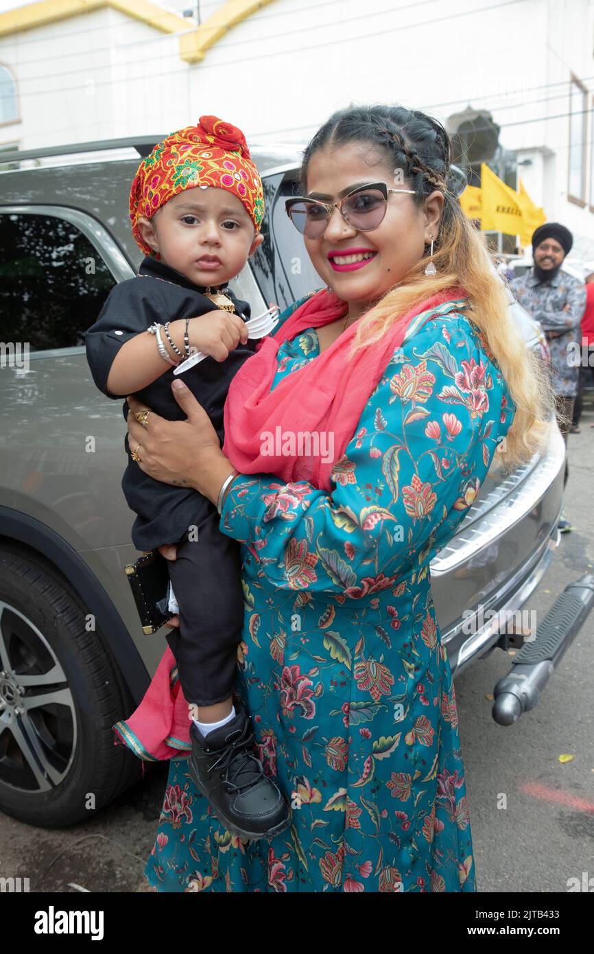 Posed portrait of an attractive Sikh mother & her infant son just ...