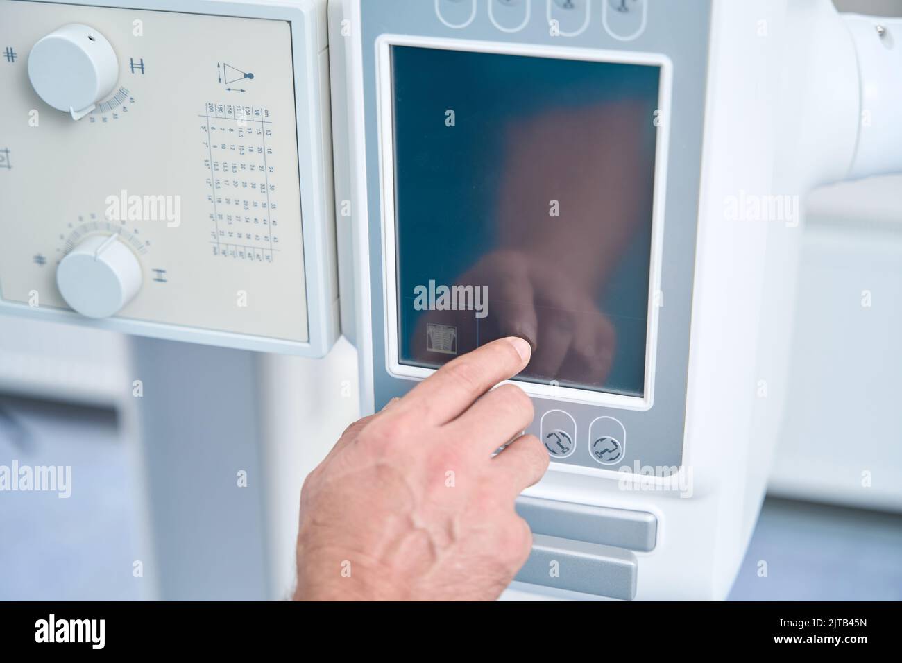 Caucasian doctor adjusting the touch panel of the x-ray machine Stock ...