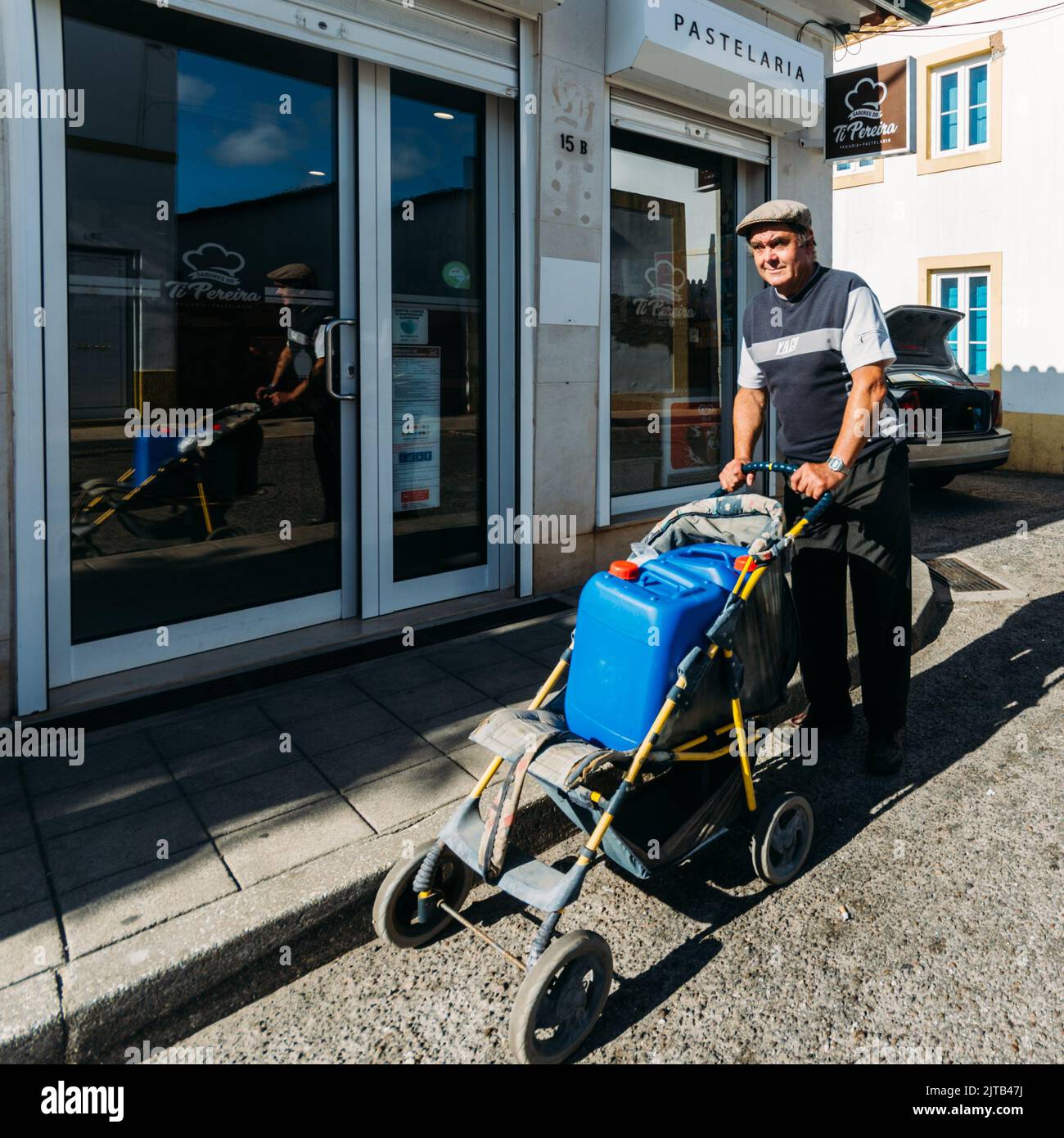 Older Portuguese man in Constancia, Portugal carrying fuel in a baby ...