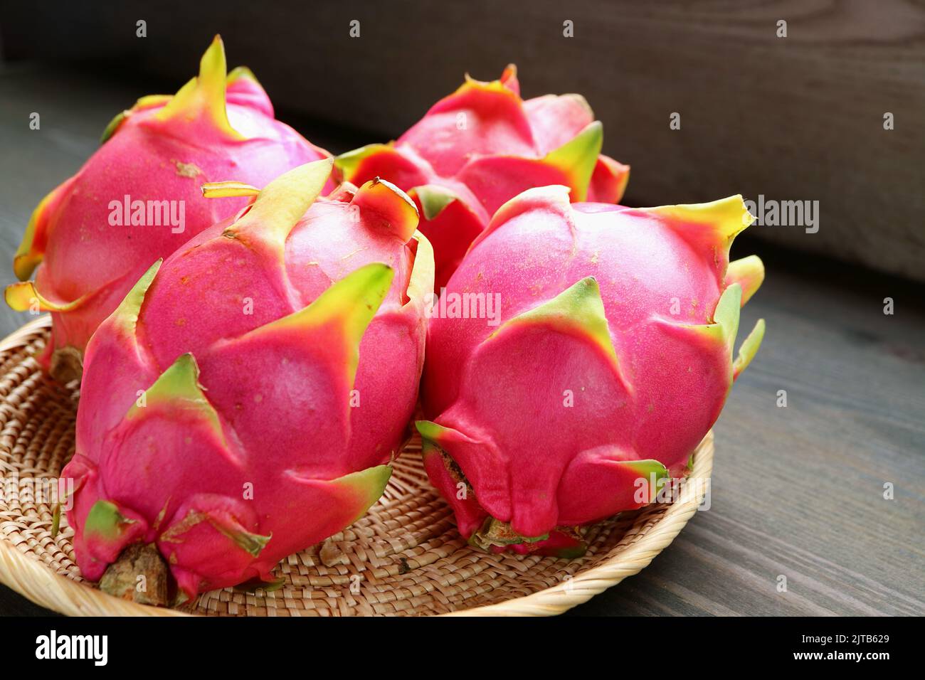 Heap of Fresh Ripe Vivid Pink Dragon Fruits in a Basket Stock Photo - Alamy