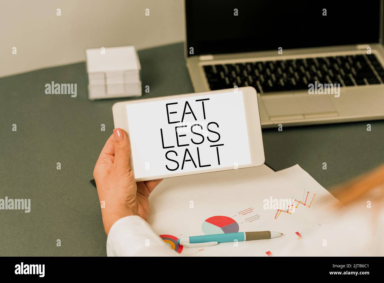 Sign displaying Eat Less Salt. Business overview Reduce the amount of ...