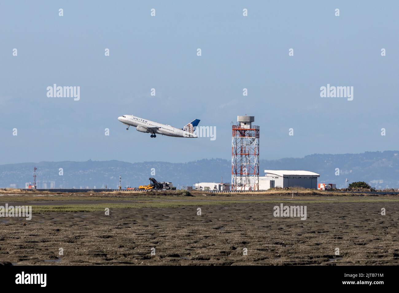A United State airlines flight takes off over the airport in San ...
