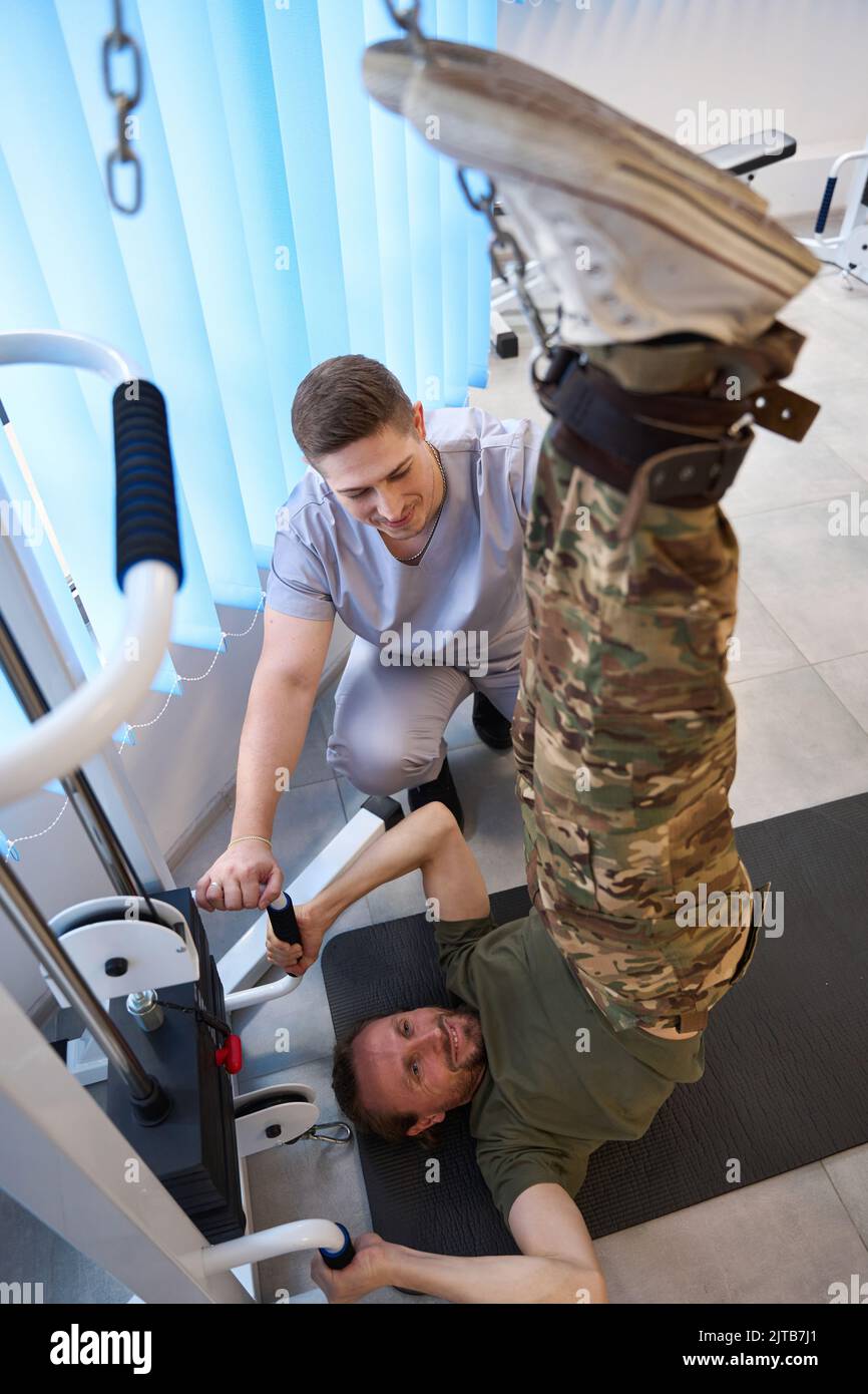 Man undergoing a spinal traction procedure after a military injury ...