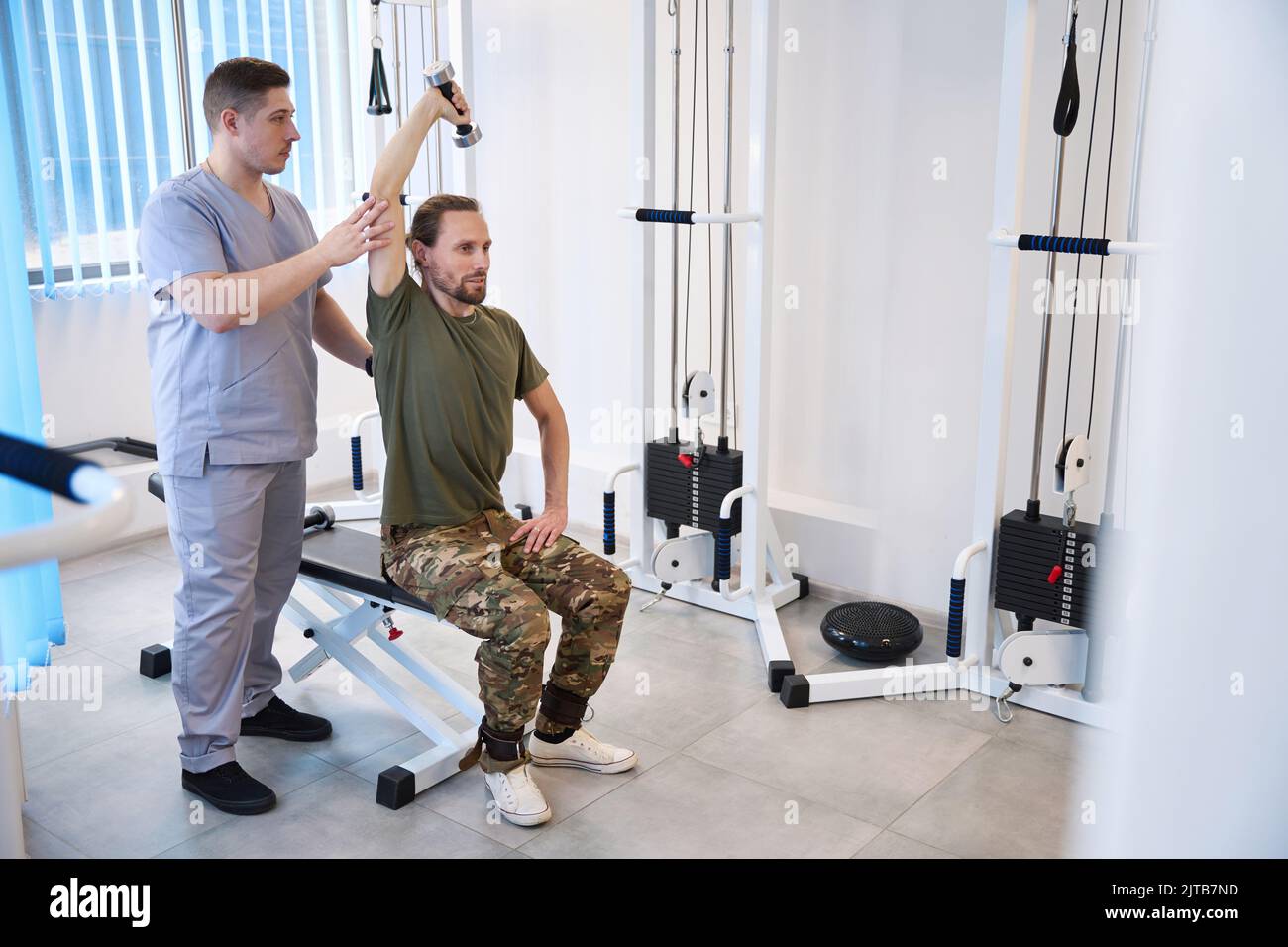 Physiotherapist corrects the implementation of therapeutic exercises ...