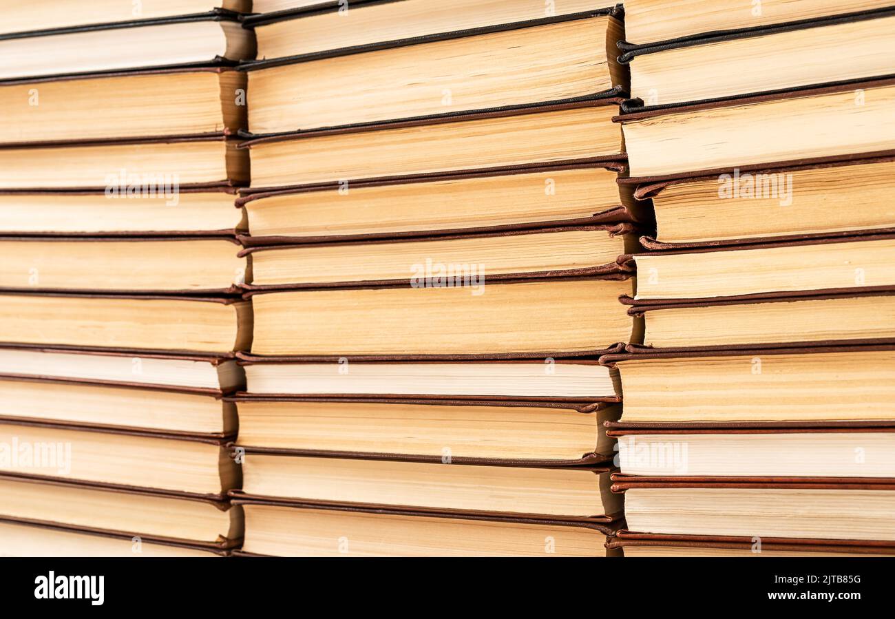 Many stacked hardcover books in library, bookstore. Knowledge, wisdom ...
