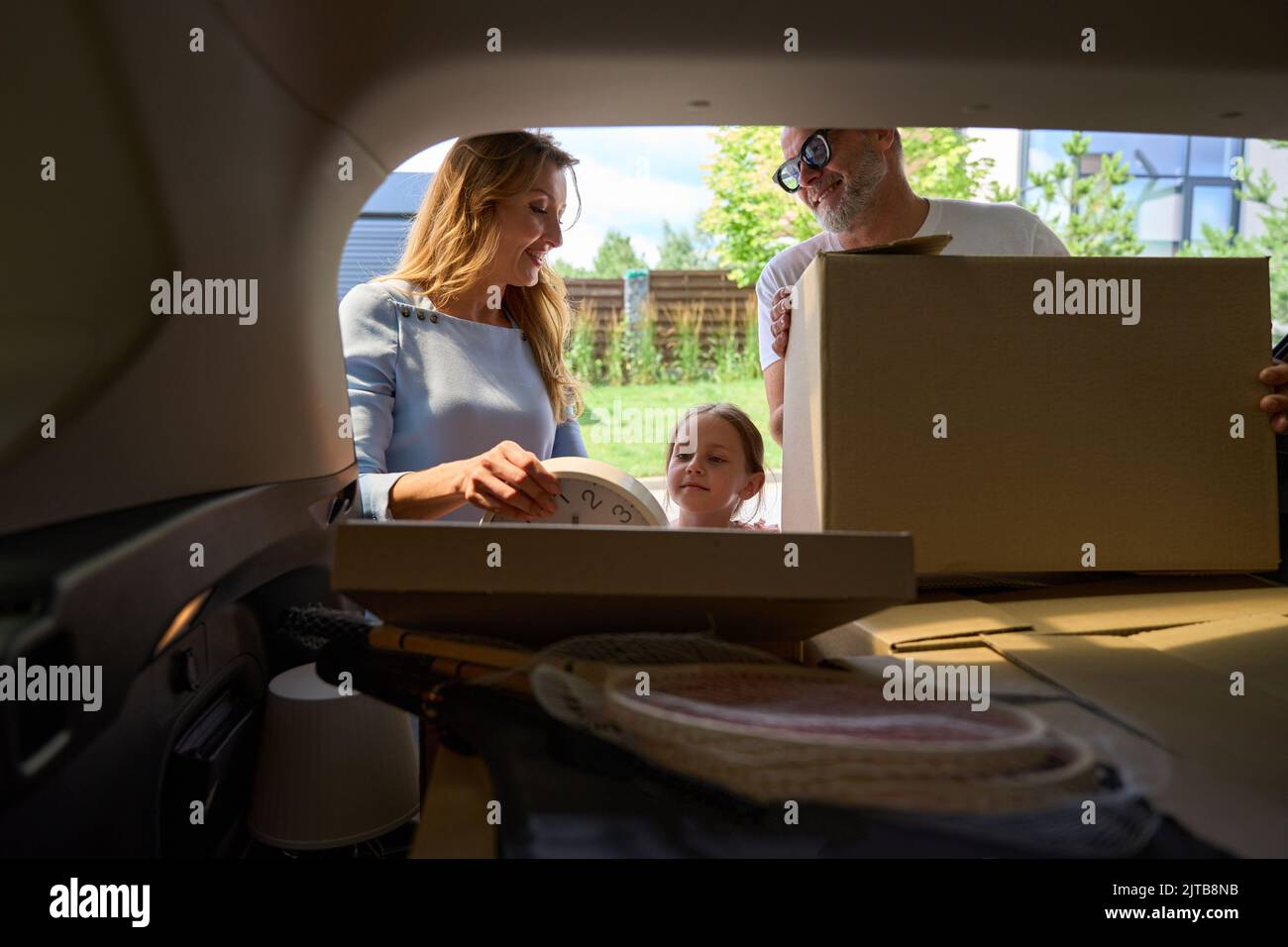 Photo from inside car family takes out boxes and things Stock Photo - Alamy