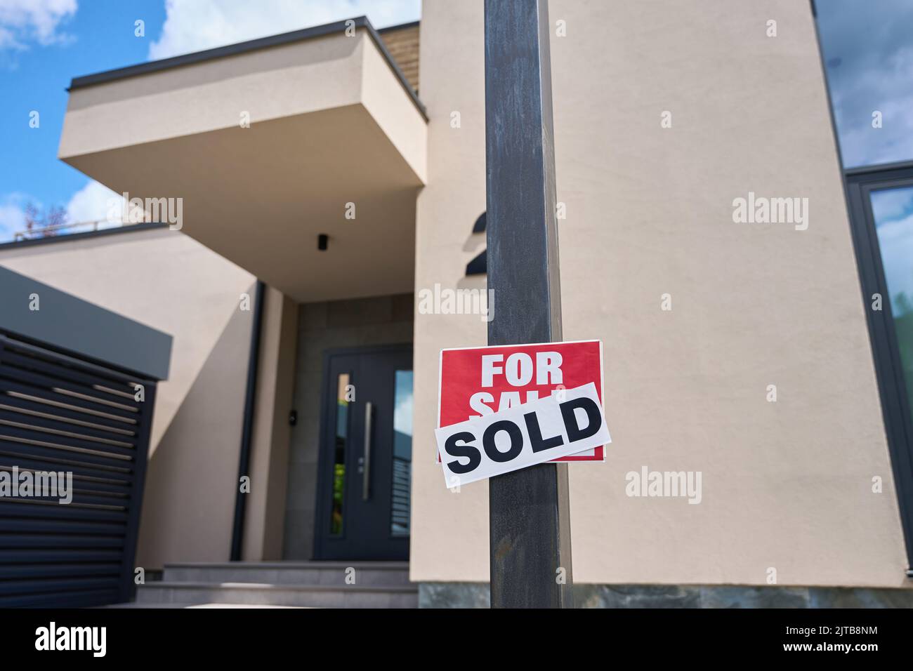 Sign for house is sold with sticker already sold Stock Photo - Alamy