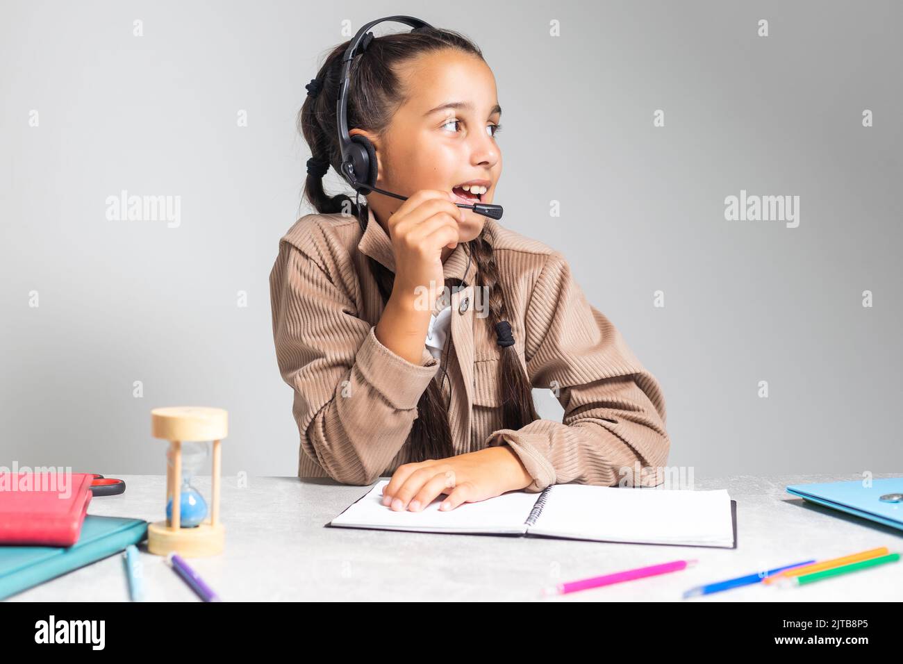 E-Learning. Shocked Little Schoolgirl Looking At Laptop Wearing ...