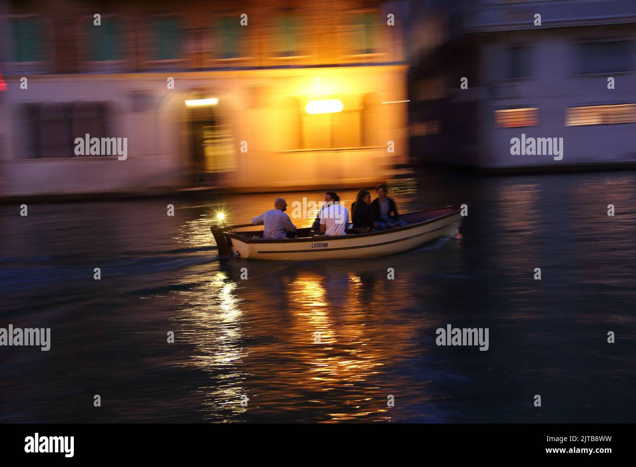 A boat driving at night in Venice Stock Photo - Alamy