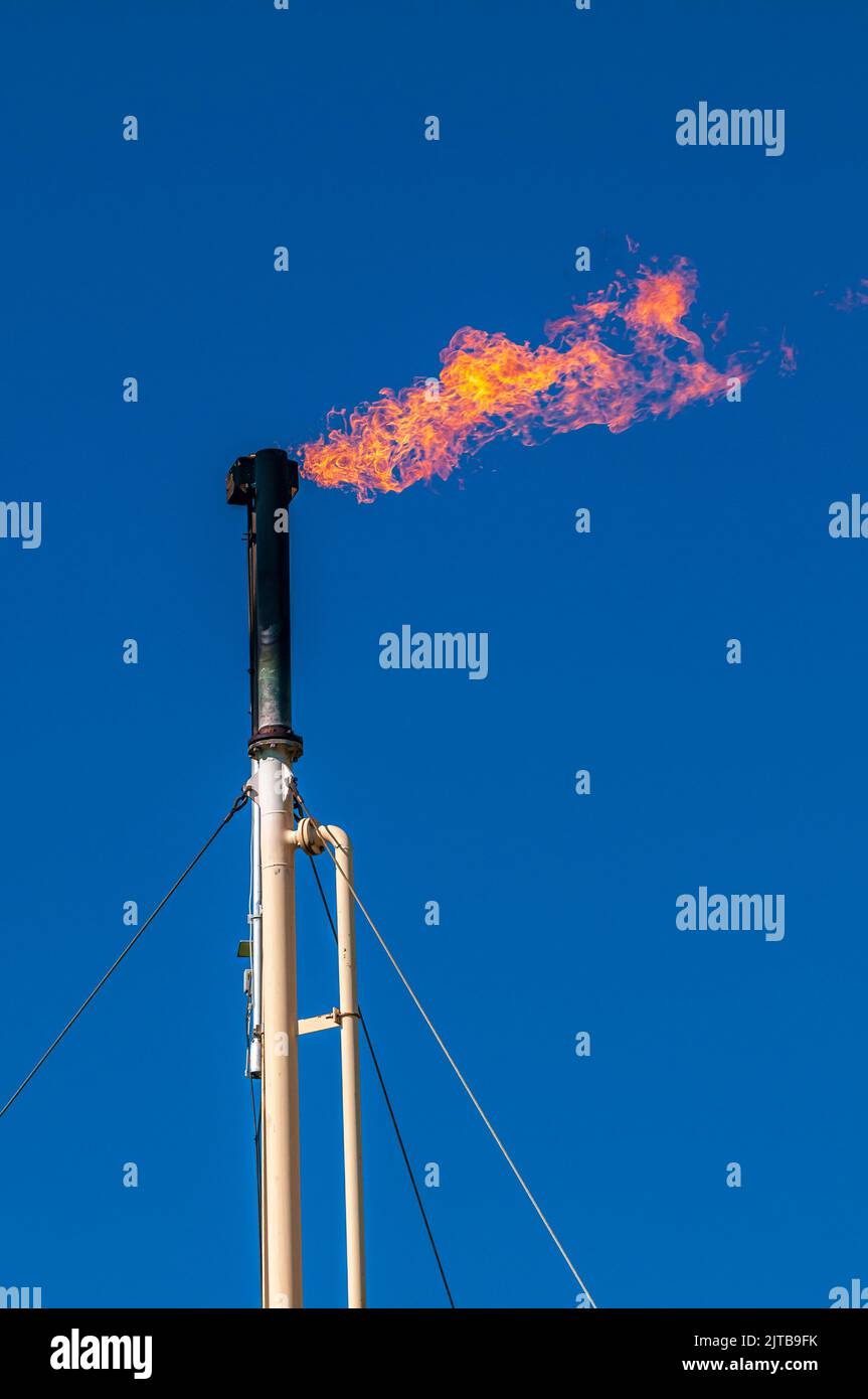 A flare stack on a sour gas well is blackened with soot Stock Photo - Alamy